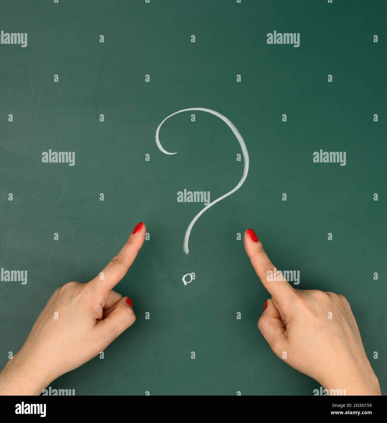 a question mark drawn in white chalk and female hands point a finger at ...