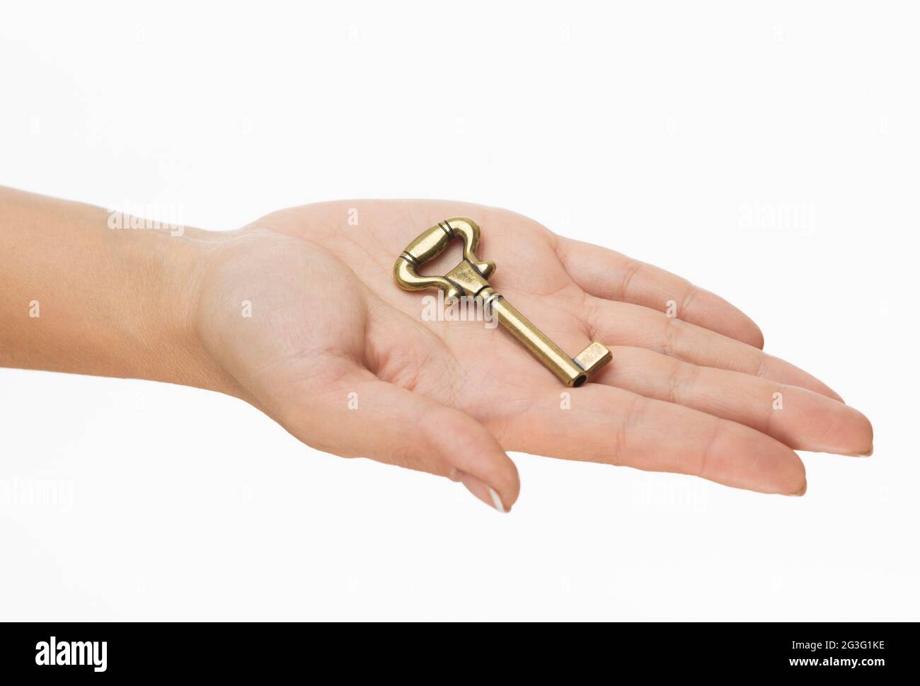 Hand with old key Stock Photo - Alamy