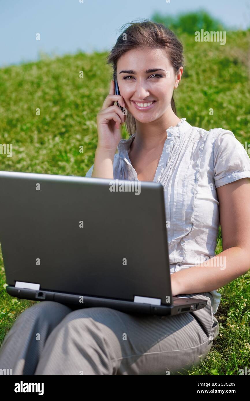 Beautiful woman with phone and notebook Stock Photo - Alamy