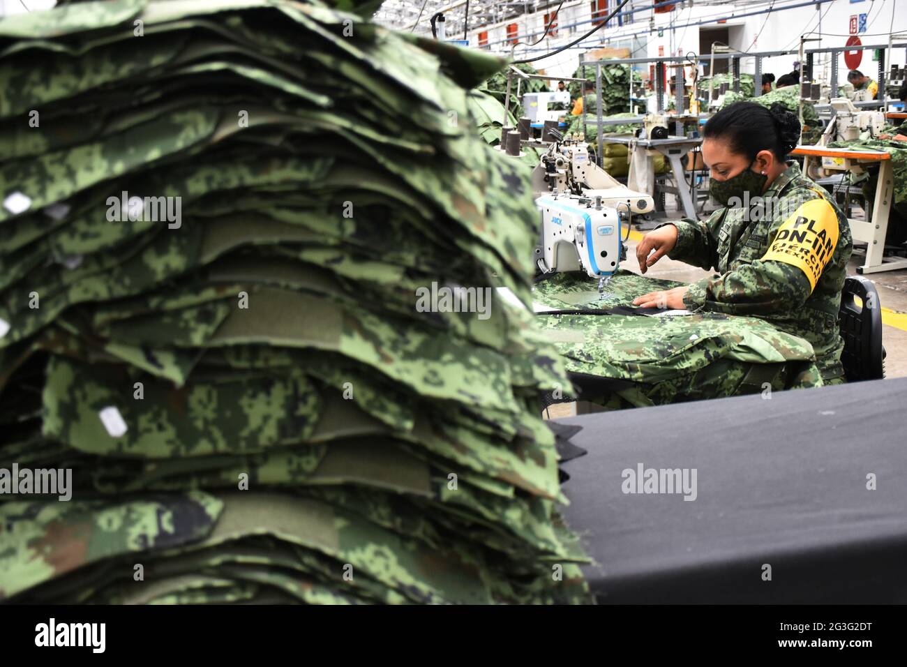 A military worker manufactures uniforms for members of Mexican Army at ...