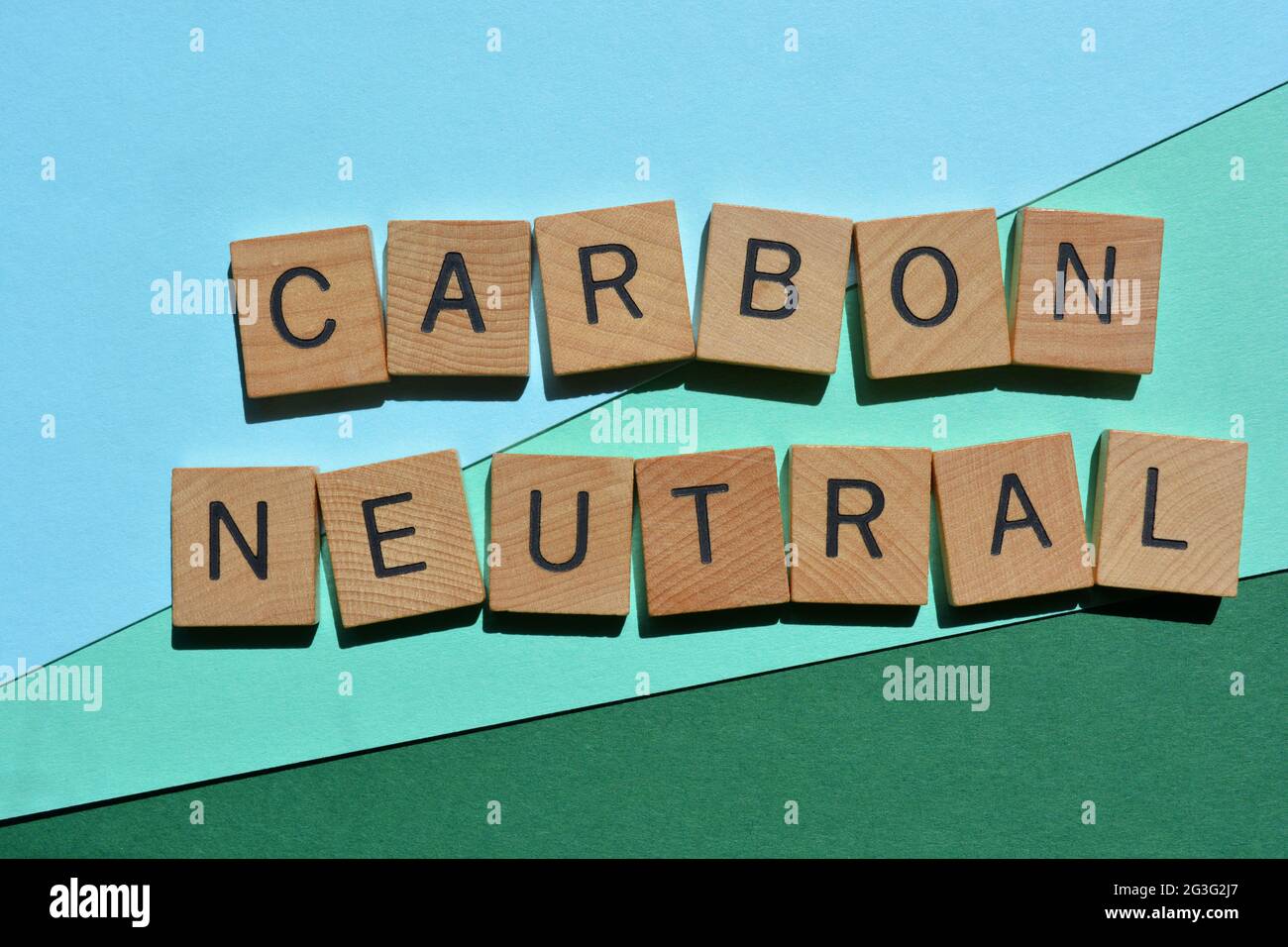 Carbon Neutral, words in wooden alphabet letters isolated on green and ...