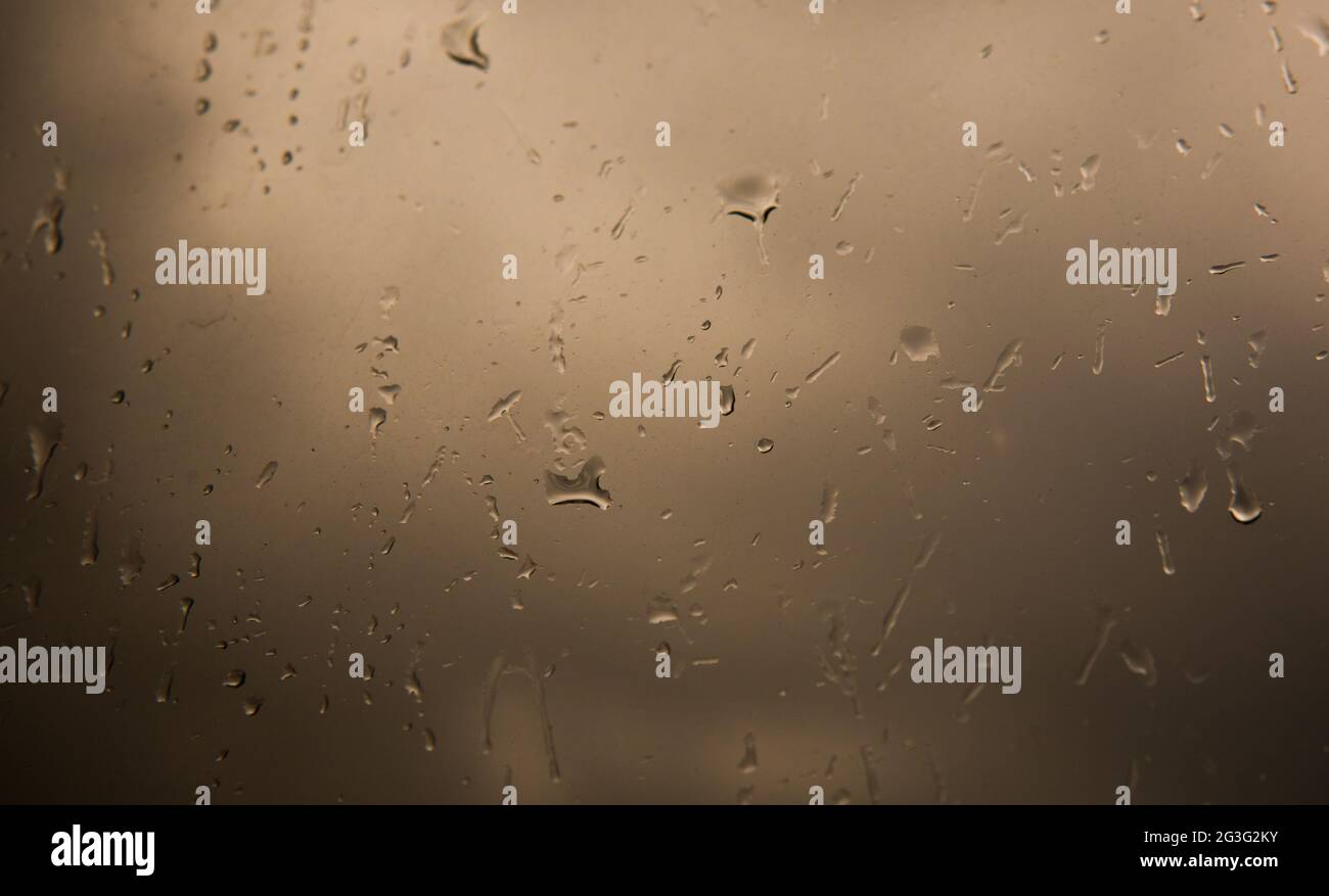 Rain drops on window across clouds Stock Photo - Alamy
