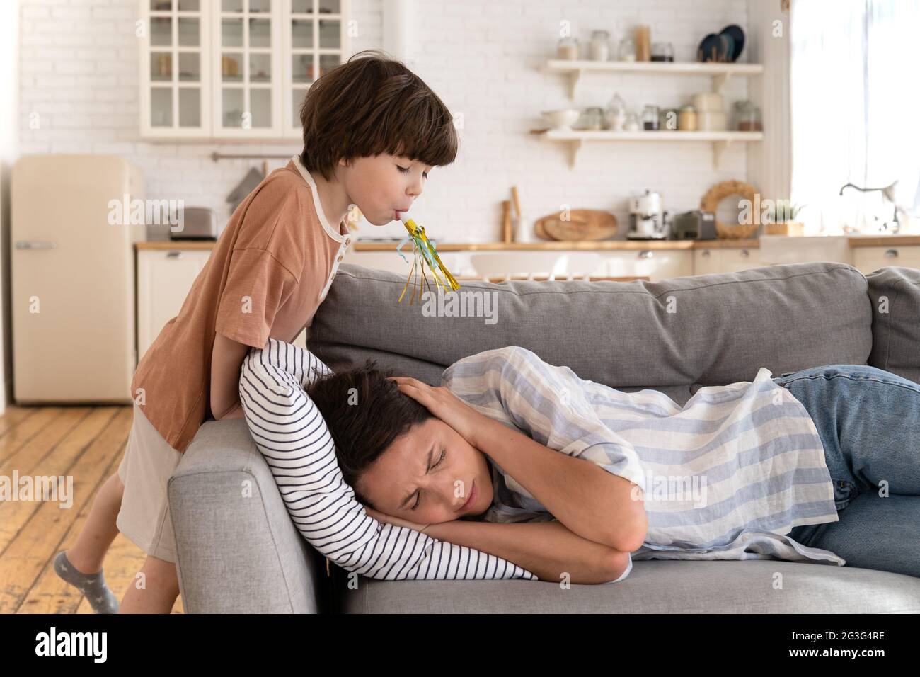 Tired single mother cover ears with hand lying eyes closed feel ...