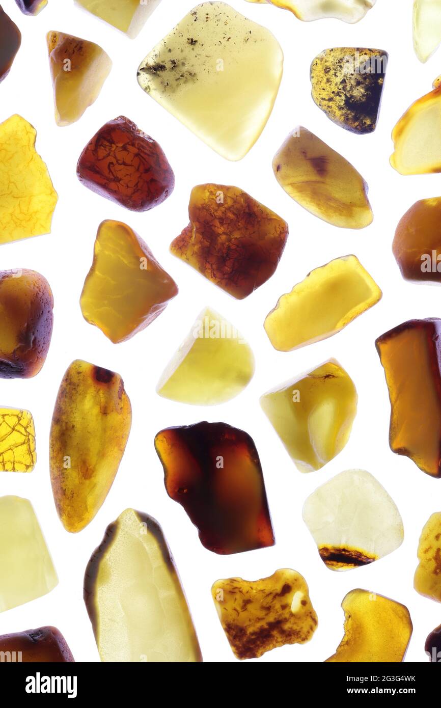 Amber rare jewel stones texture on half light white surface background ...