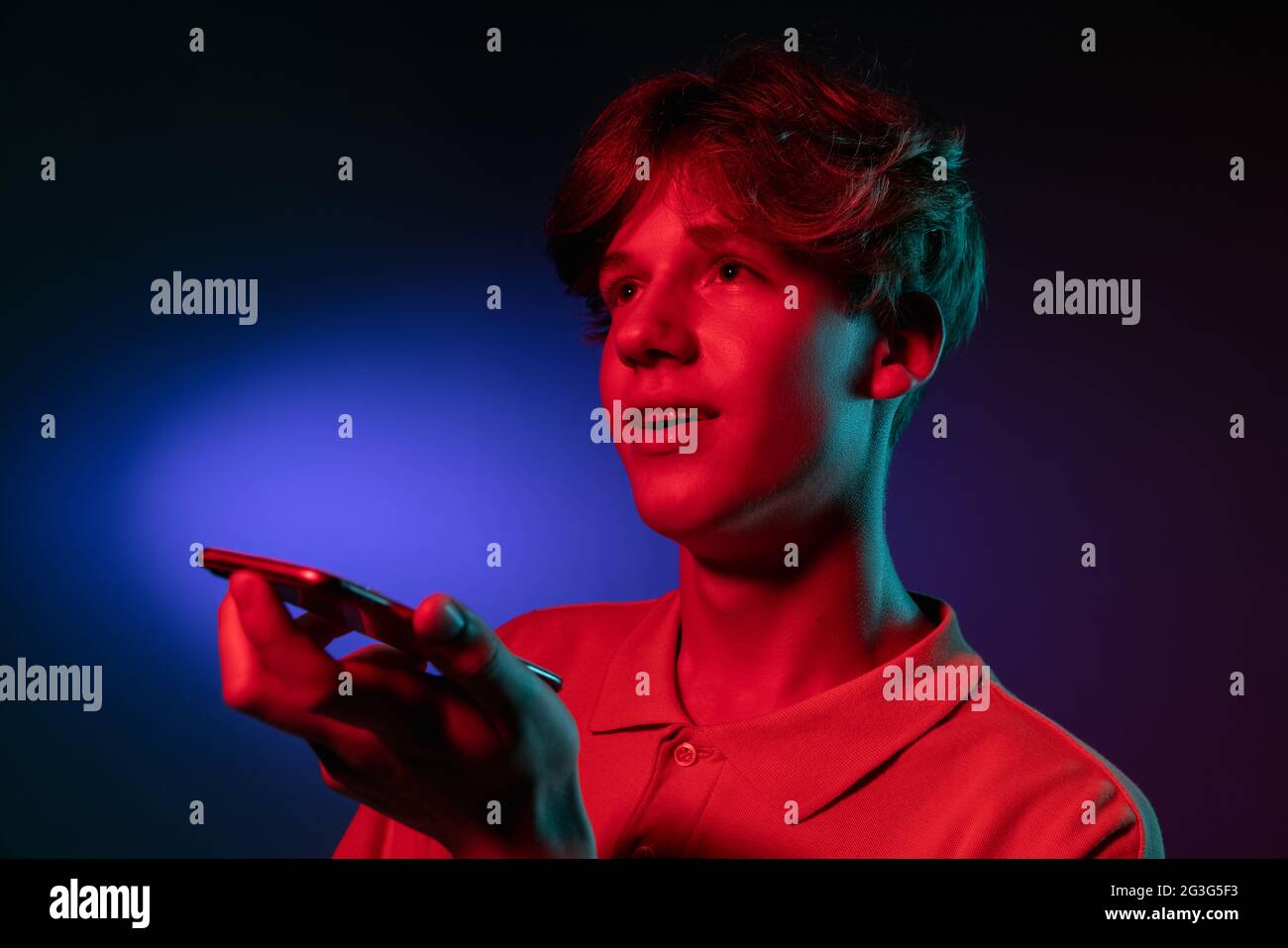 Recording voice message. man's modern portrait on gradient orange ...