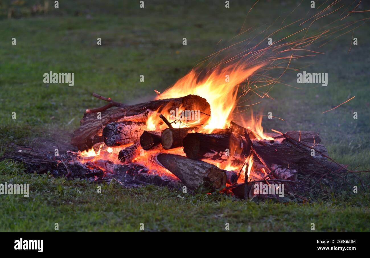 a bonfire burns in a clearing during a summer camp Stock Photo - Alamy