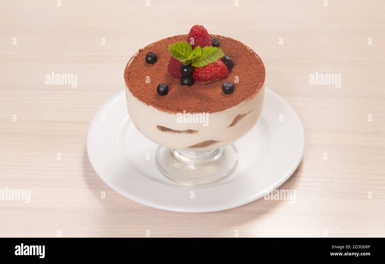 Tiramisu cake in glass with small fruits Stock Photo - Alamy