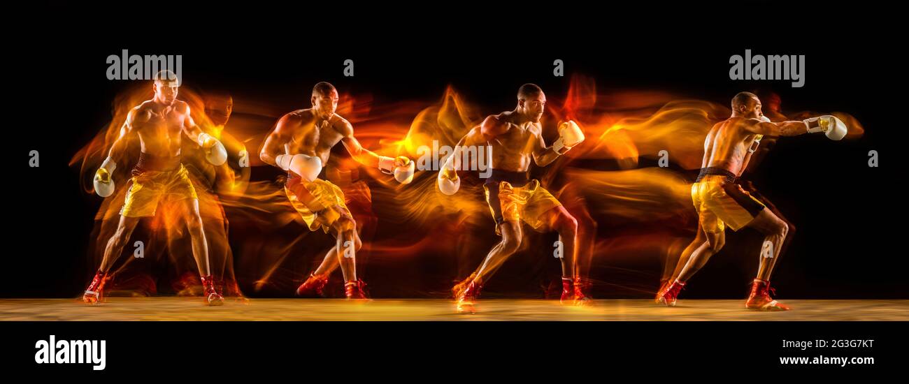 Professional african-american boxer training on black studio background ...