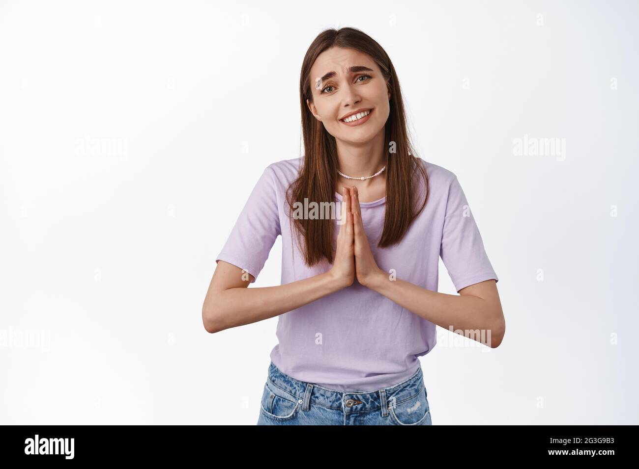 Portrait of coy cute young woman beg you, say please and asking for ...