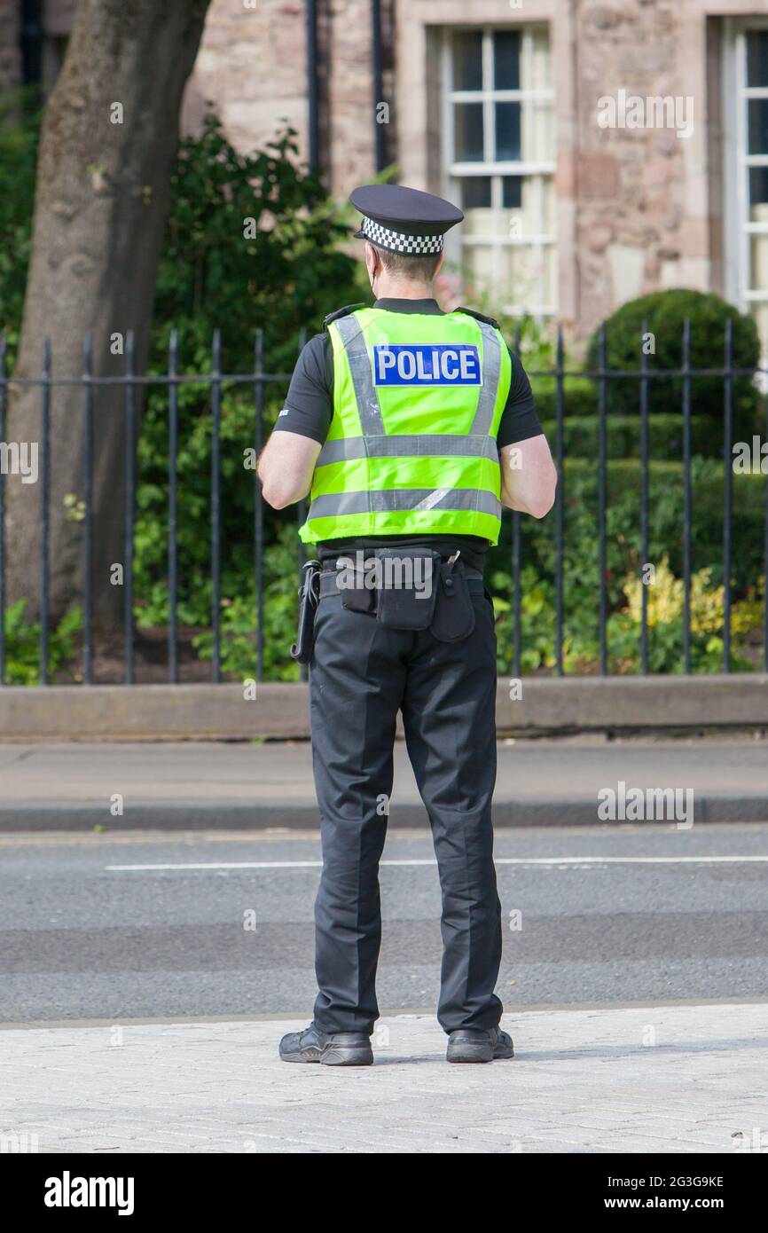 EDINBURGH, SCOTLAND - JULY 21: Police officer on guard duty near the ...