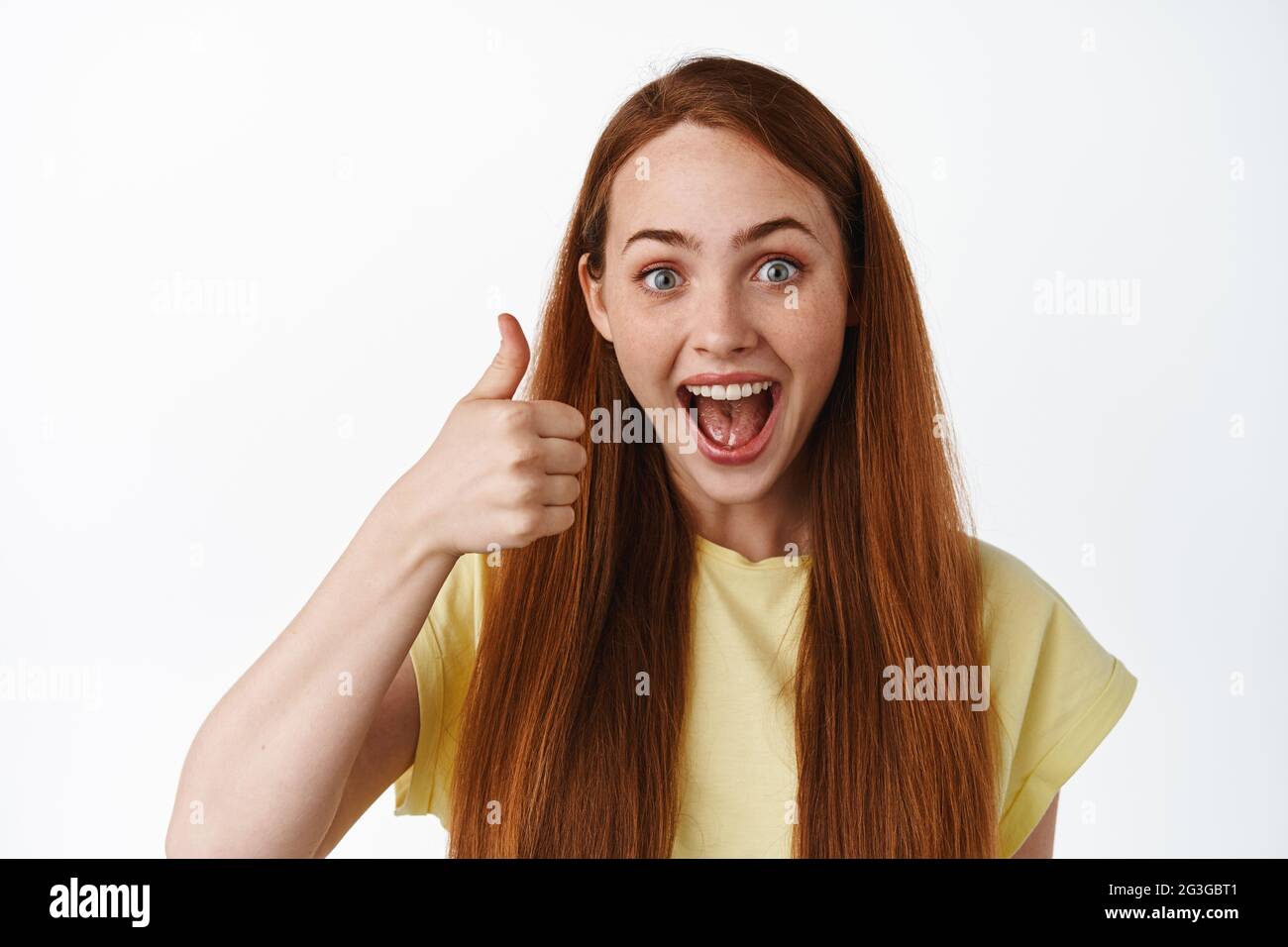 Very good, nice work. Impressed redhead girl shows thumb up and look ...