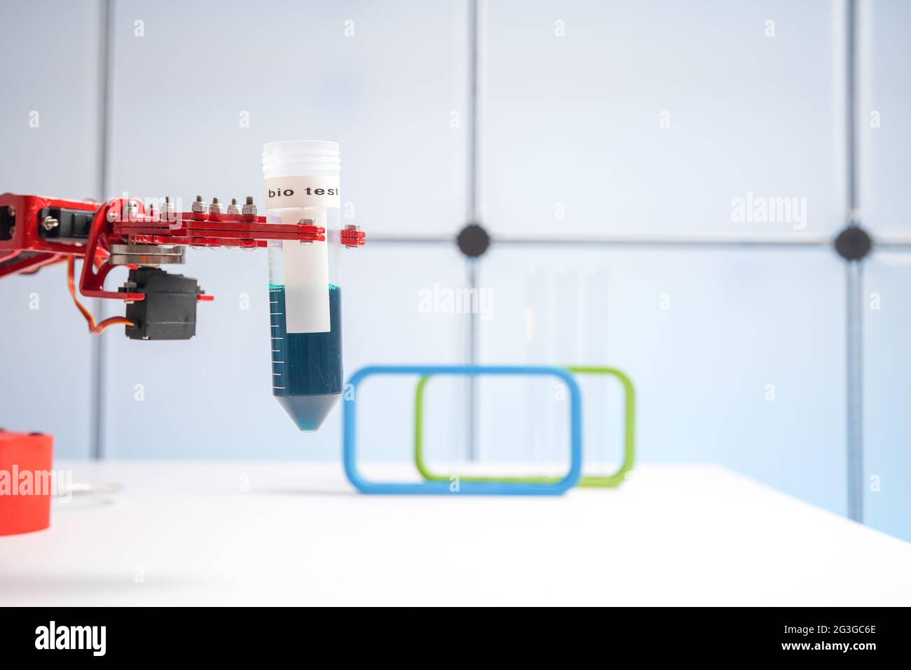 Robot arm with test tube with biological sample in science laboratory ...