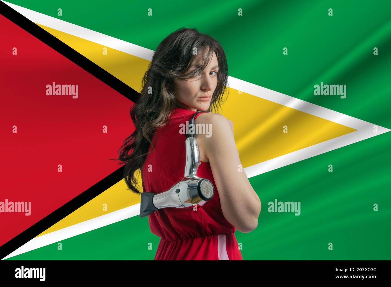 Beauty industry in Guyana. Happy female hairdresser holding hairdryer ...