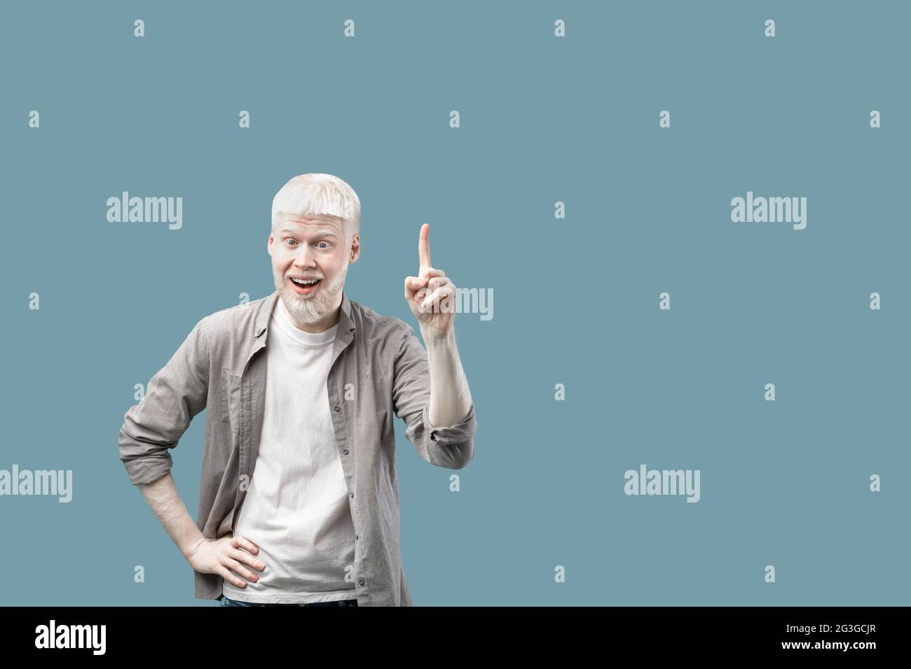 Great idea. Excited albino man pointing finger up, having aha moment ...
