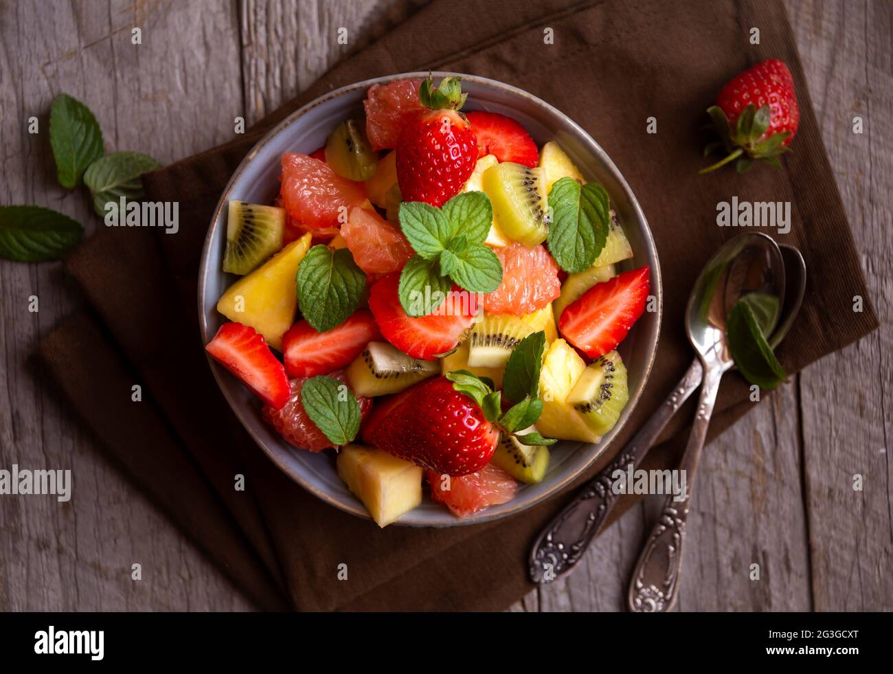 Fruit salad with cut fresh fruit and mint leaves Stock Photo - Alamy