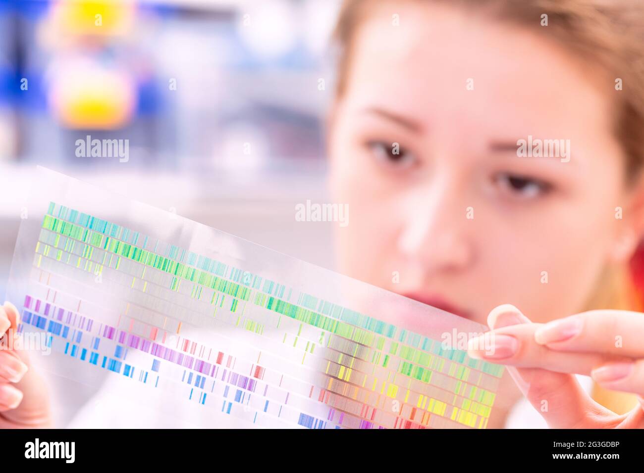 Young woman examines a spectroscopy picture in a quantum physics ...