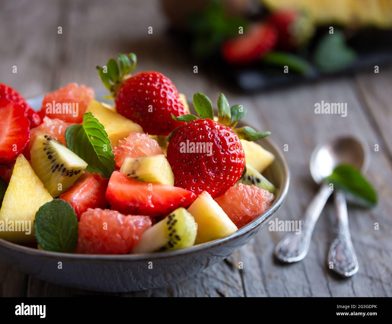 Fruit salad with cut fresh fruit and mint leaves Stock Photo - Alamy