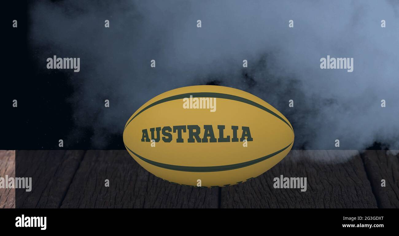 Yellow rugby ball with australia text over wooden surface against smoke ...