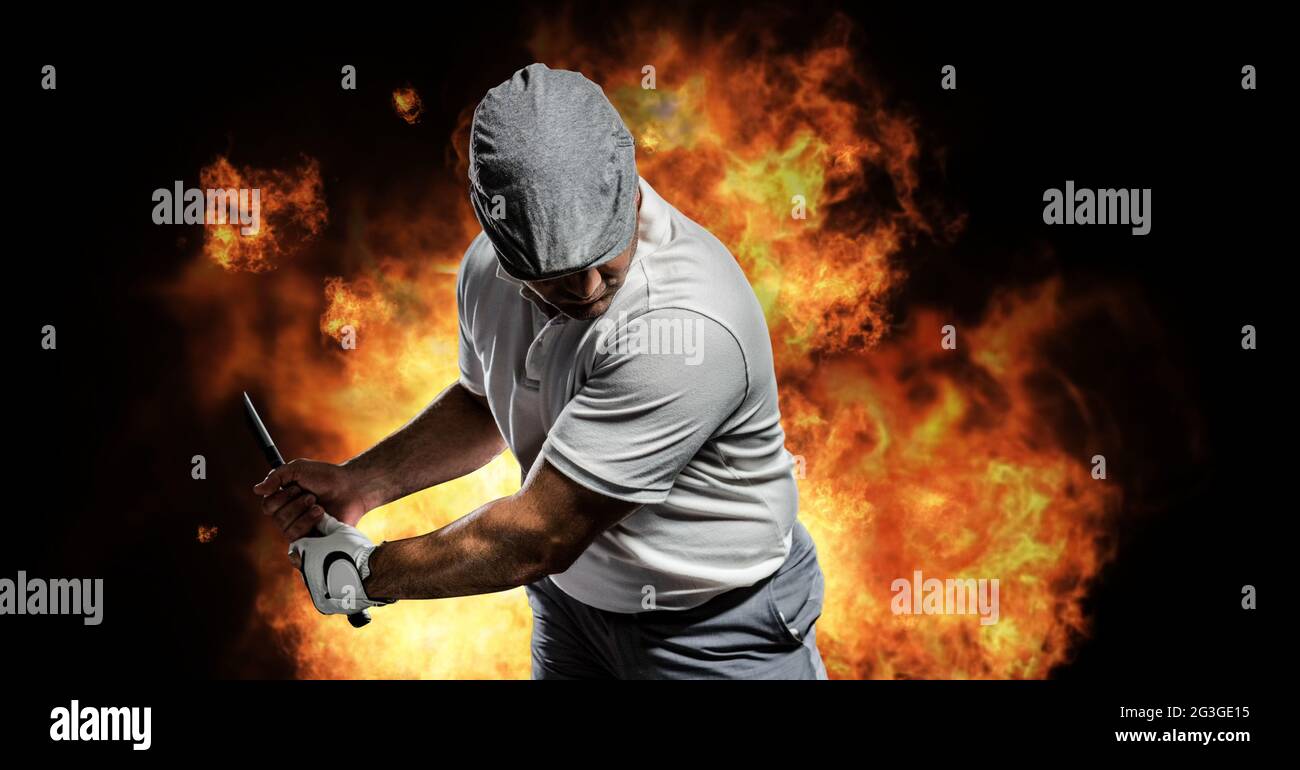 Caucasian senior male golf player swinging club against fire flame ...
