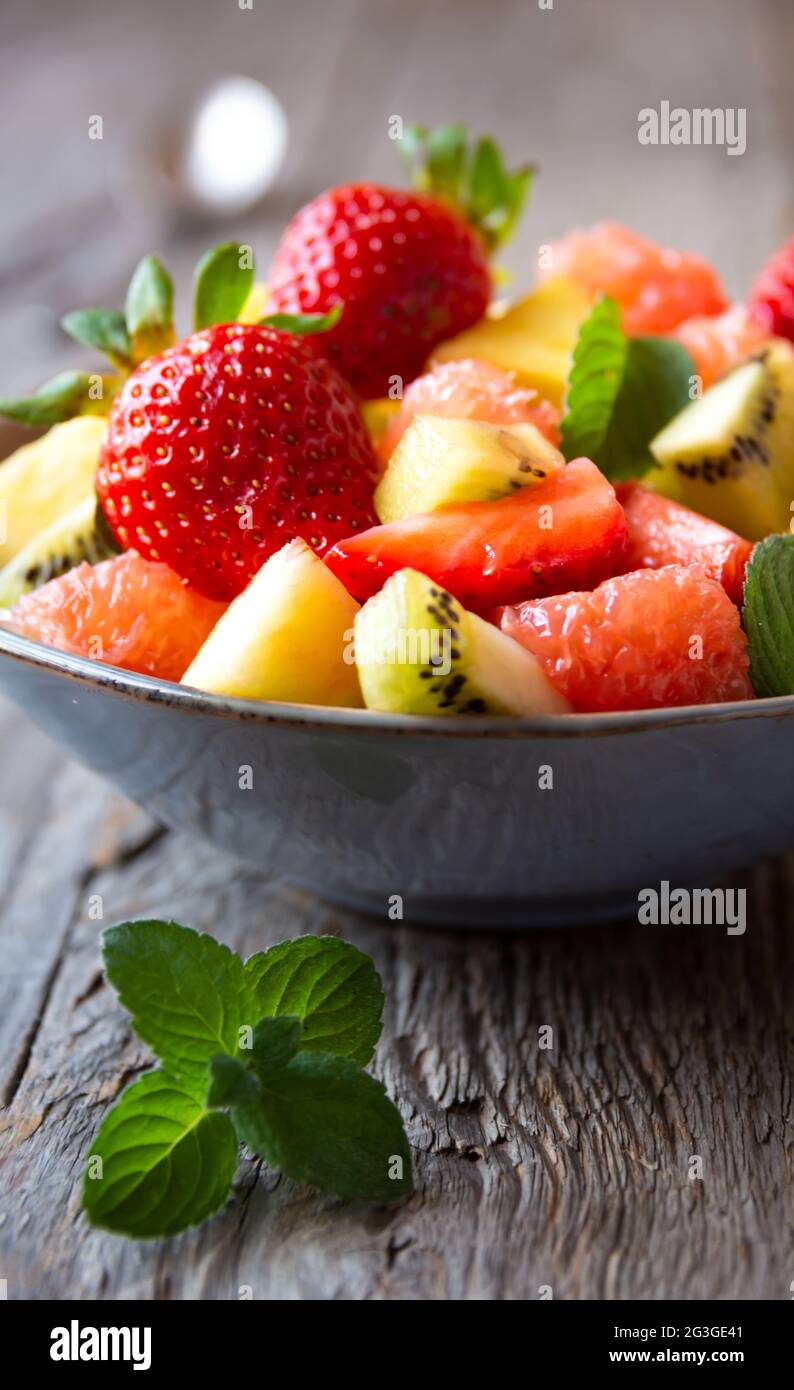Fruit salad with cut fresh fruit and mint leaves Stock Photo - Alamy