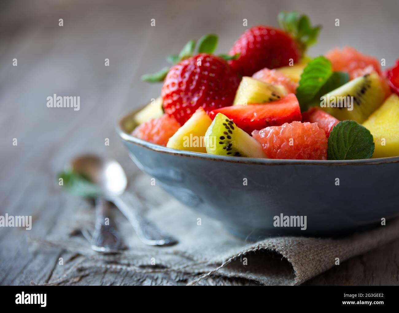 Fruit salad with cut fresh fruit and mint leaves Stock Photo - Alamy