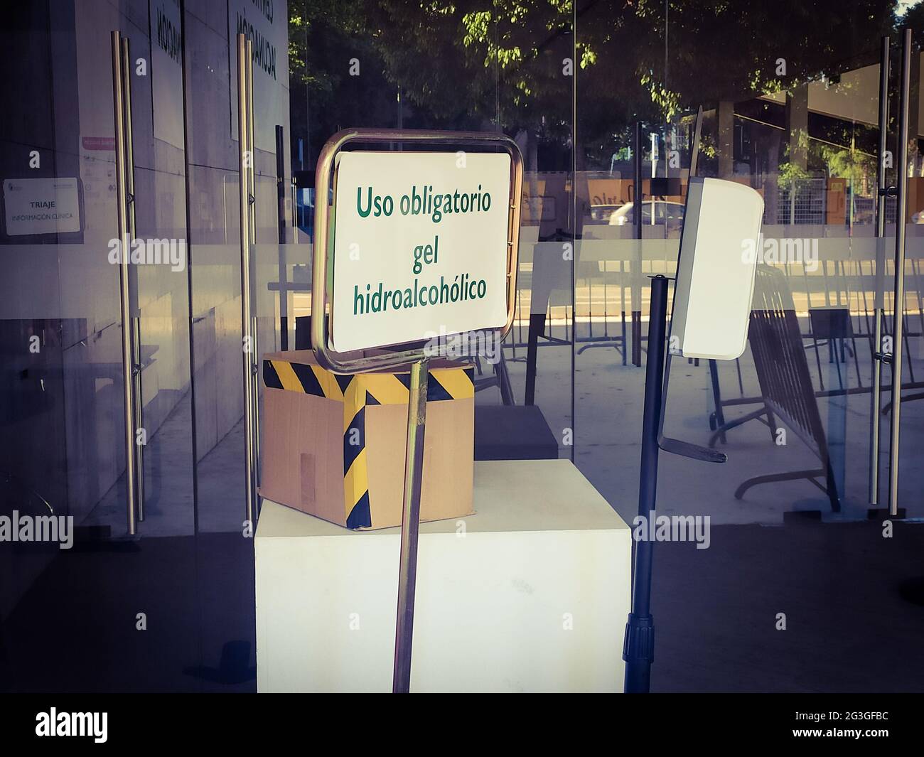 Closeup of a " MANDATORY USE OF ALCOHOL GEL" sign on a building ...
