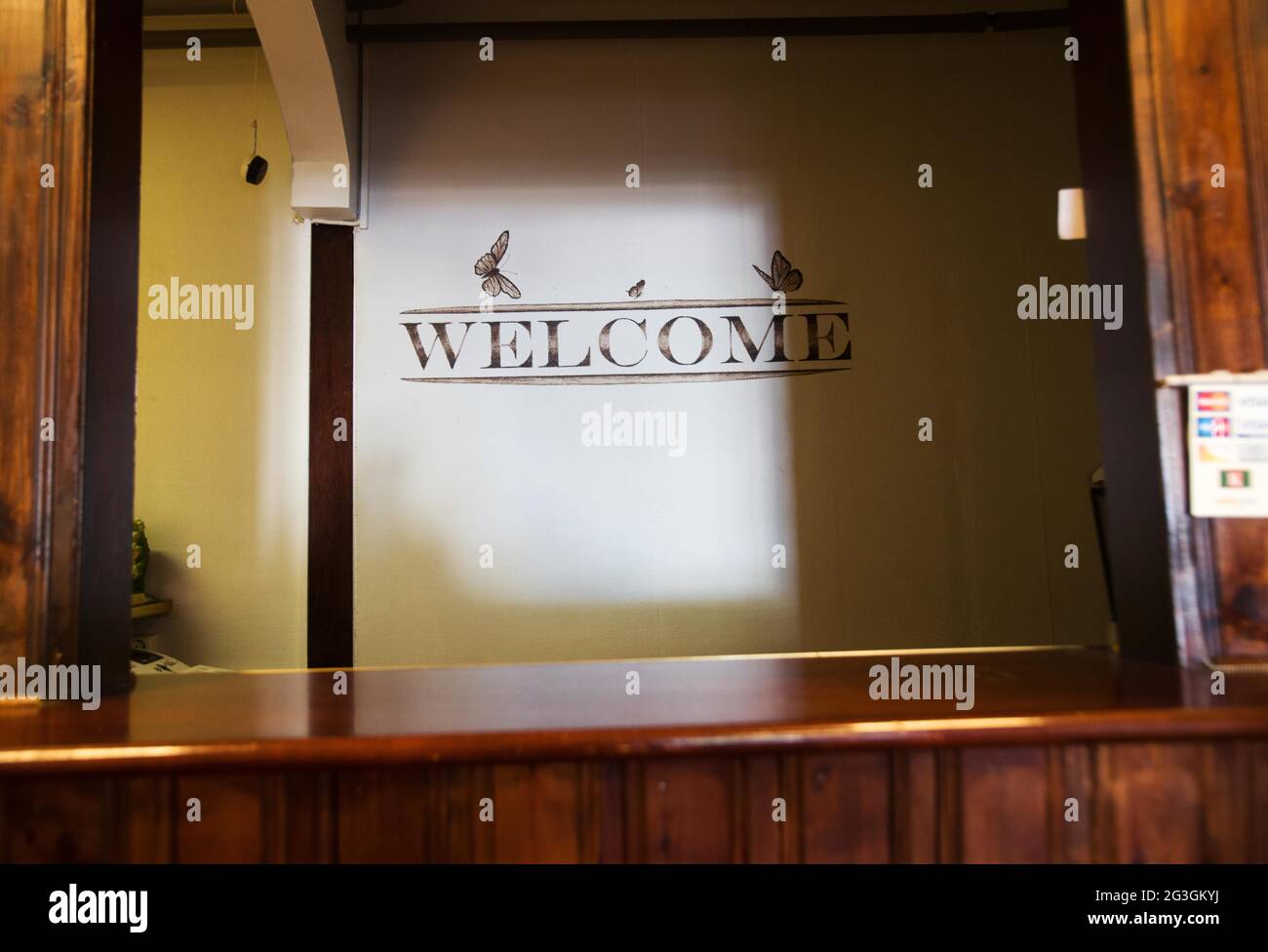 Welcome sign in an old hotel Stock Photo - Alamy