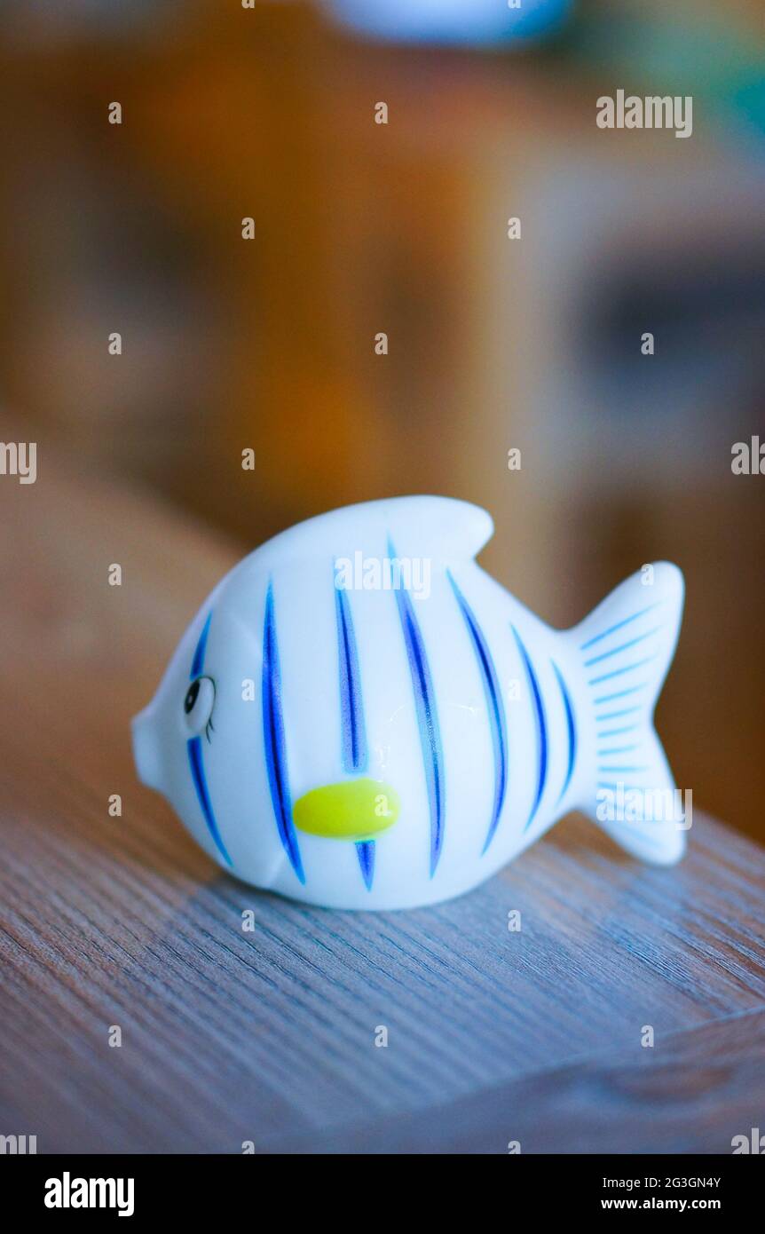 Plastic toy fish on a wooden table Stock Photo - Alamy