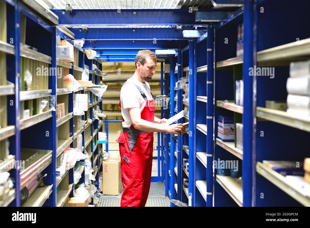 car repair shop employees in the warehouse for spare parts for ...