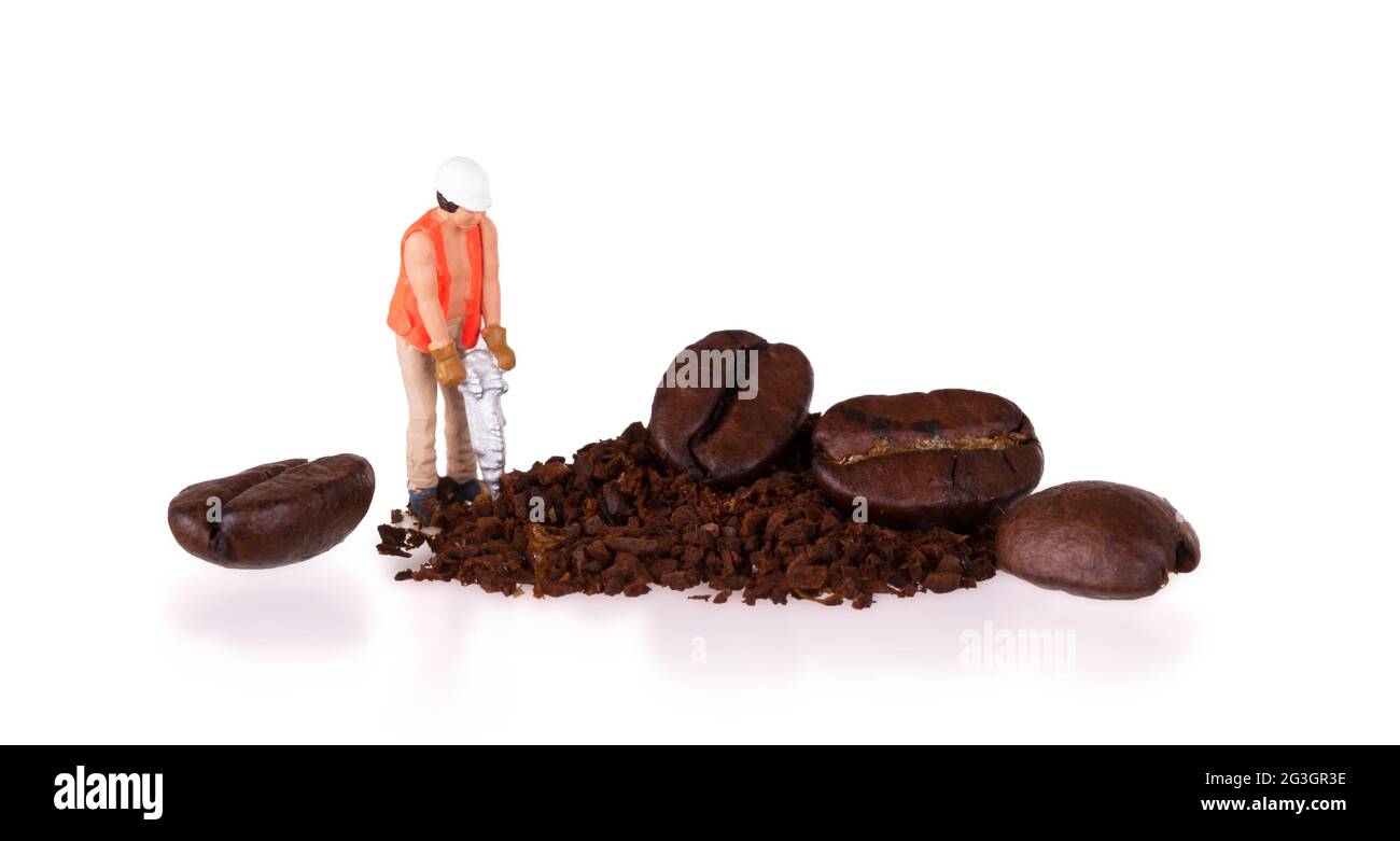 Miniature worker working on a coffee bean Stock Photo - Alamy
