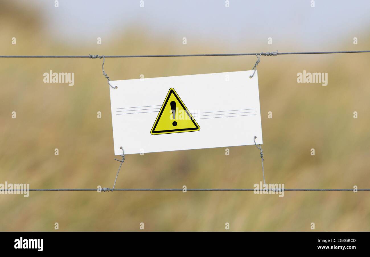 Border fence - Old plastic sign with a flag Stock Photo - Alamy