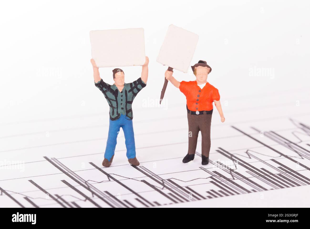 Tiny person demonstrating on a graph Stock Photo - Alamy