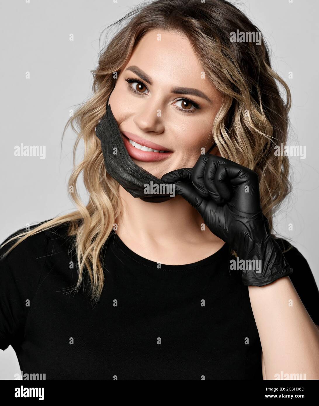 Woman taking off her shirt hi-res stock photography and images - Alamy