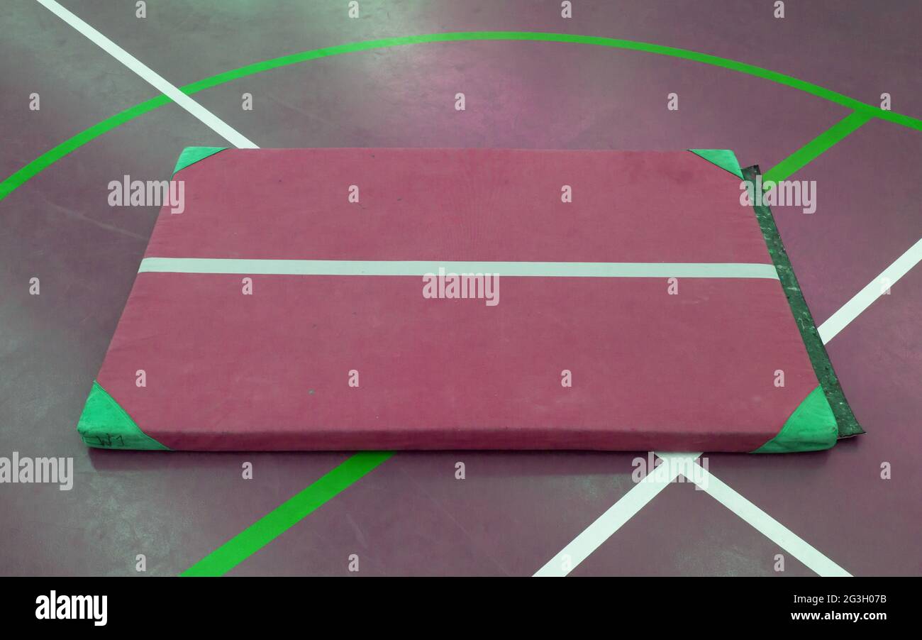 Very old red mat on a blue court Stock Photo - Alamy