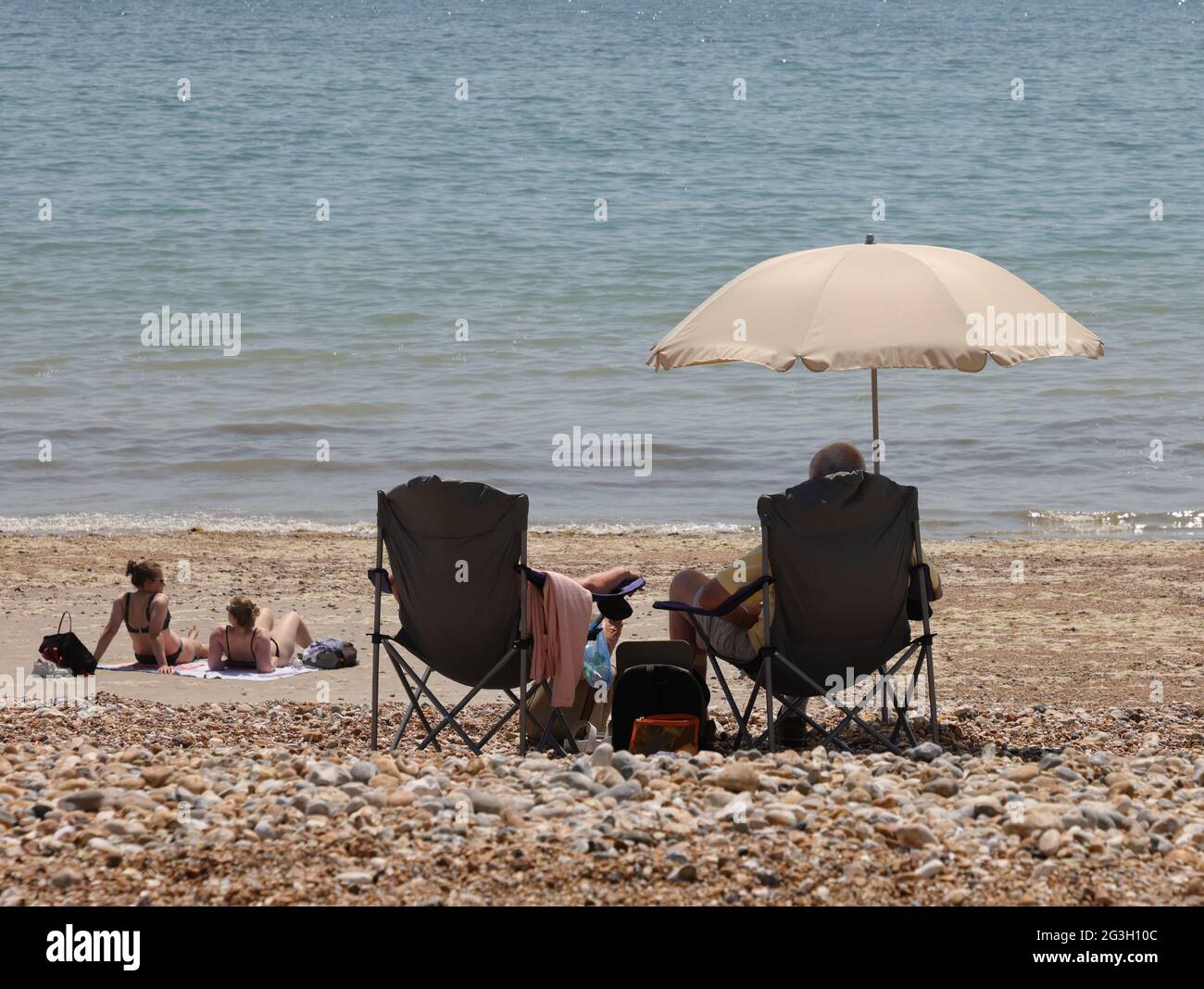 People seen sitting in chairs on the beach of Bognor Regis, during a ...