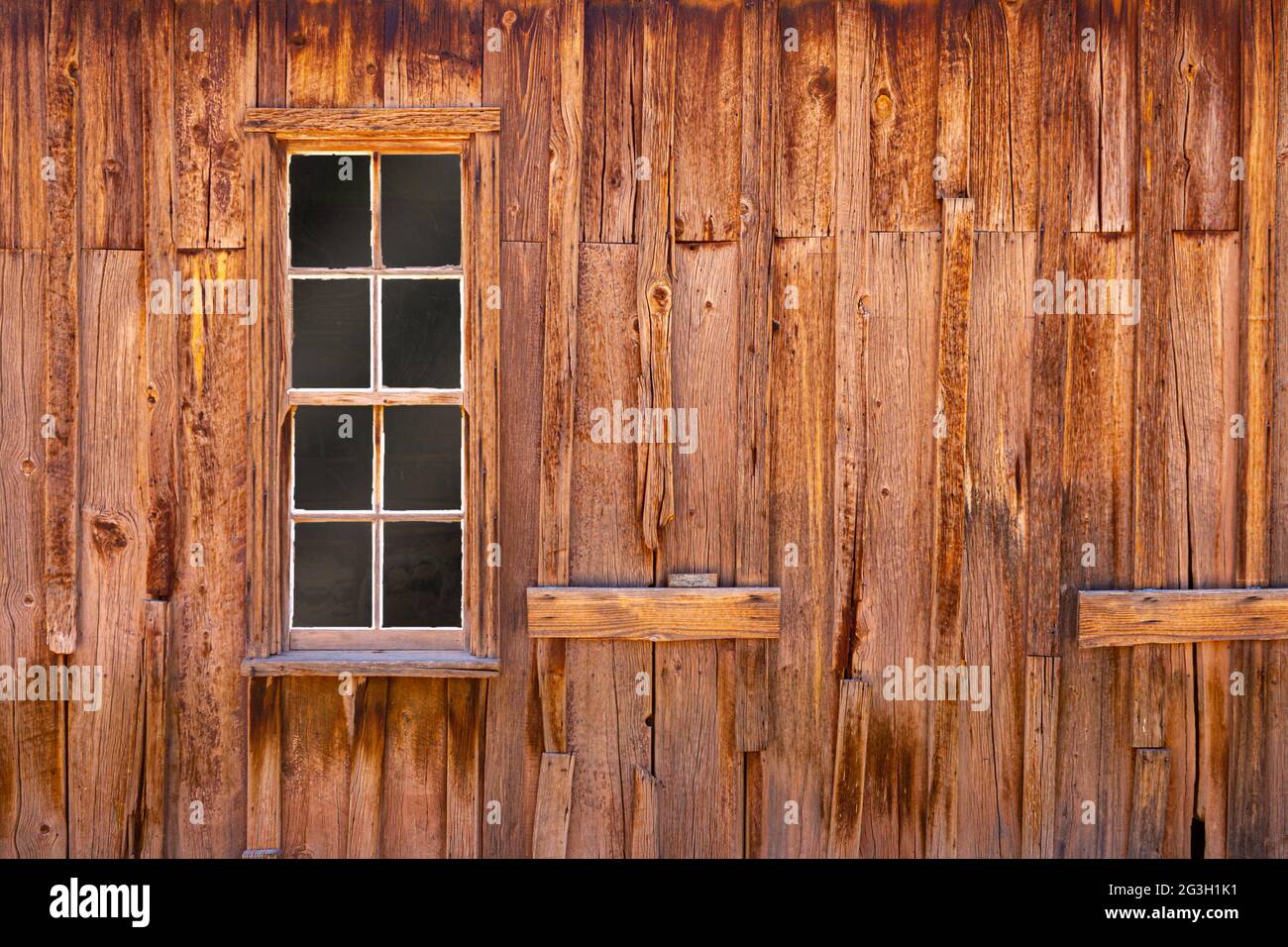 Old western rustic wooden style exterior wall with a framed window ...