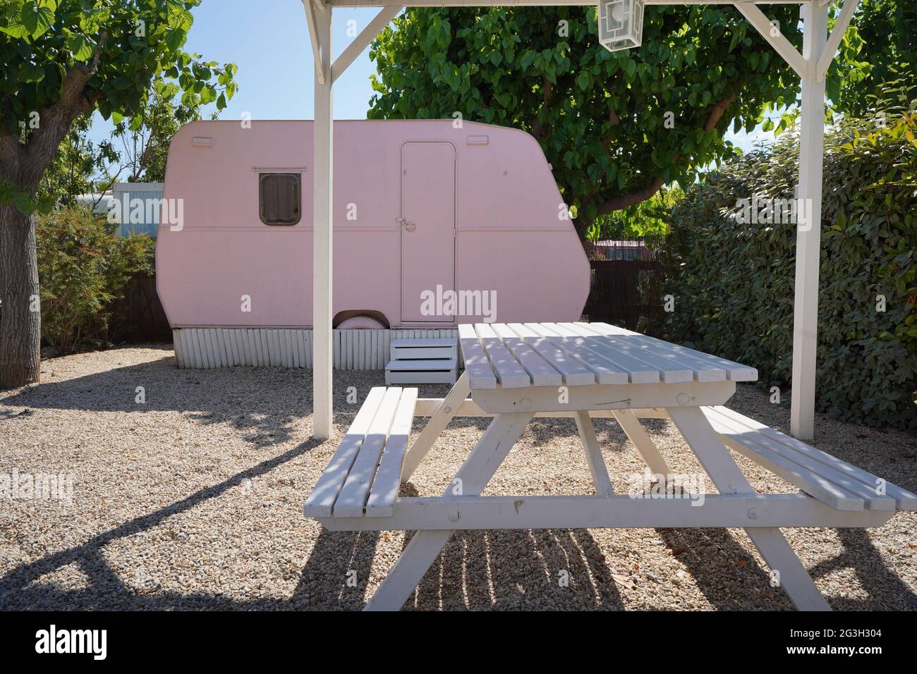 Small cabin with pink walls and a yard Stock Photo - Alamy