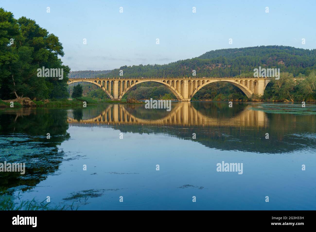 Arch suspension bridge over a river Stock Photo - Alamy