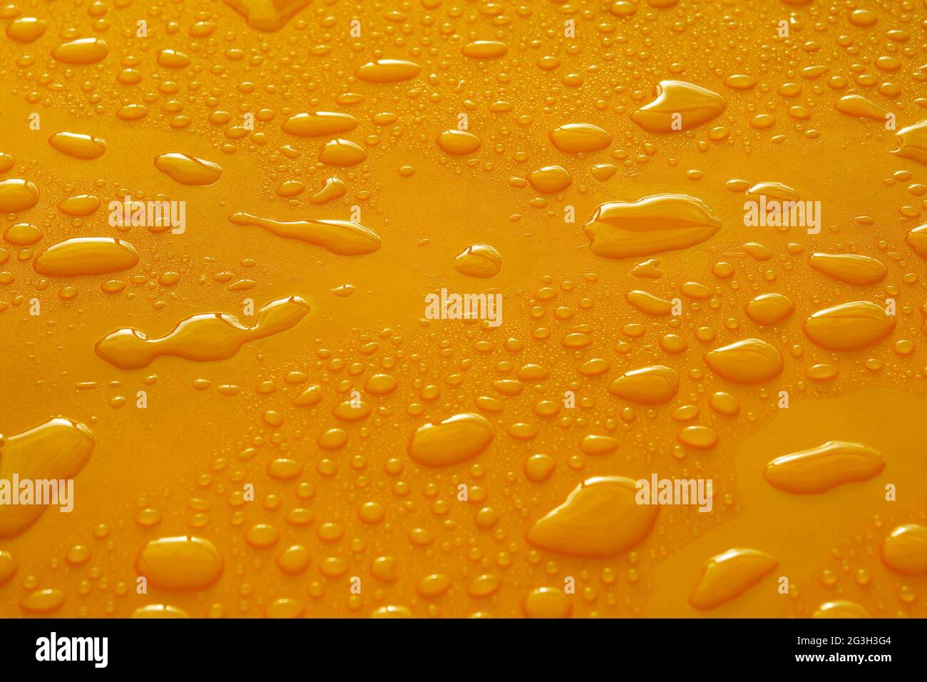random water drops on flat yellow surface after rain Stock Photo - Alamy