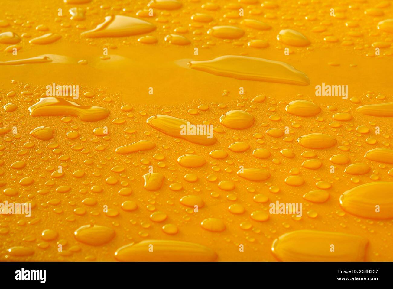 random water drops on flat yellow surface after rain Stock Photo - Alamy