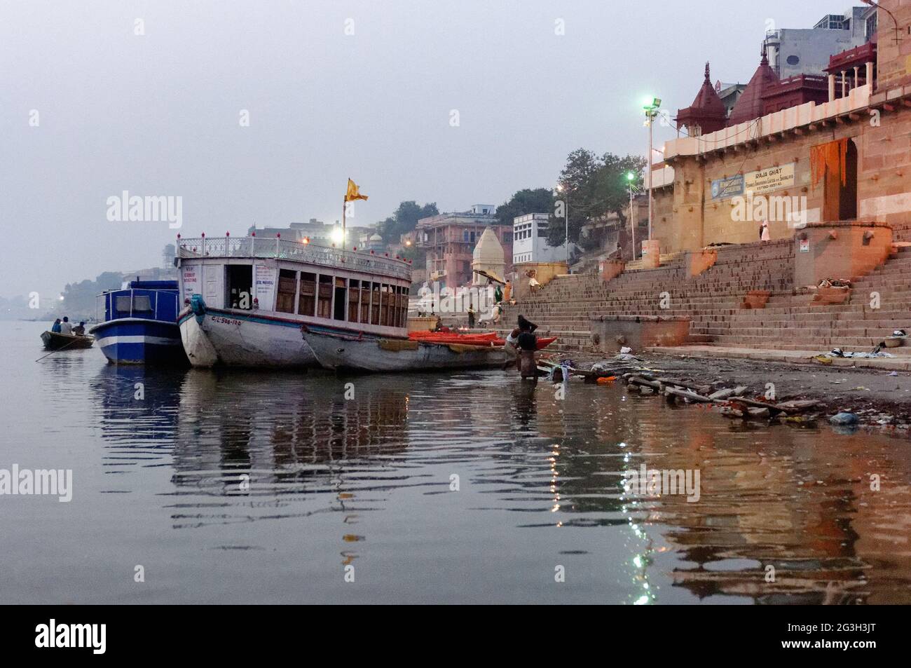 Boats used to carry people and tourists on the River Ganges are moored ...