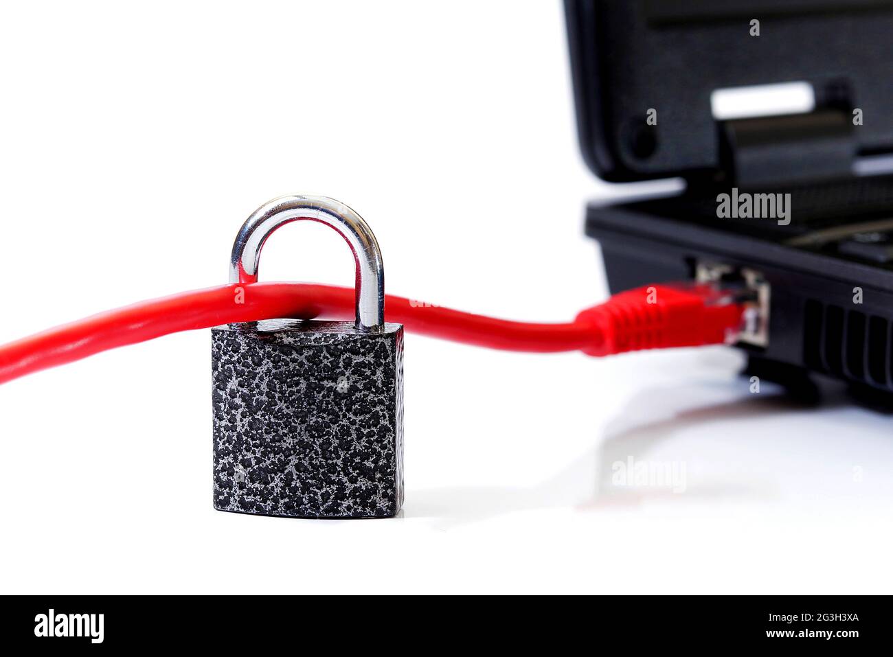 padlock locked on red network cable connected to laptop on white ...