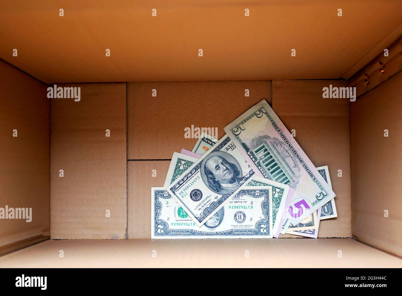 assorted dollar banknotes on the bottom of cardboard box Stock Photo ...