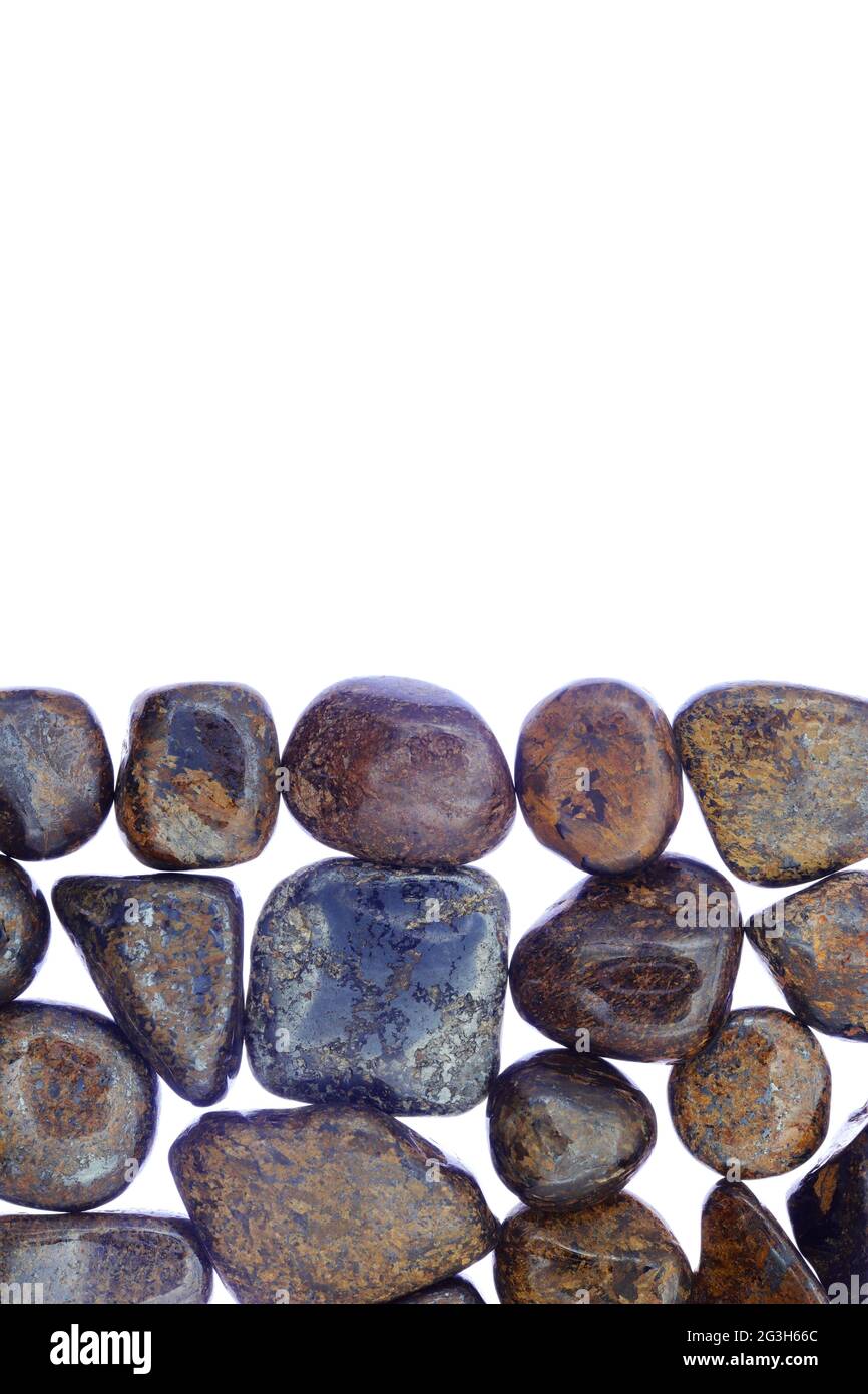 Bronzite heap jewel stones texture on half white light isolated ...