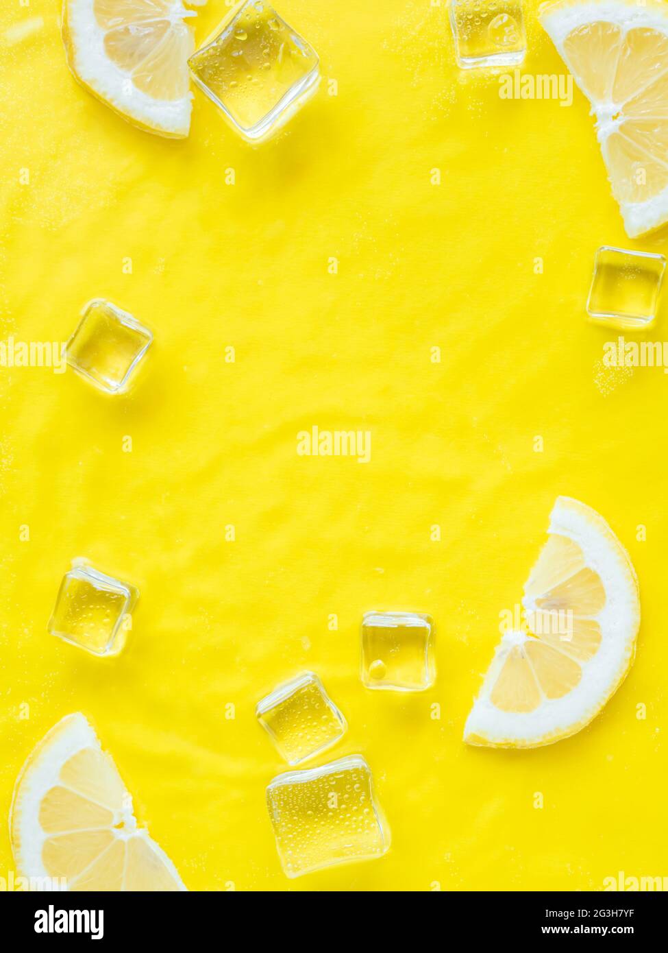 Intense yellow lemon citrus slice in cool water with ripples texture ...