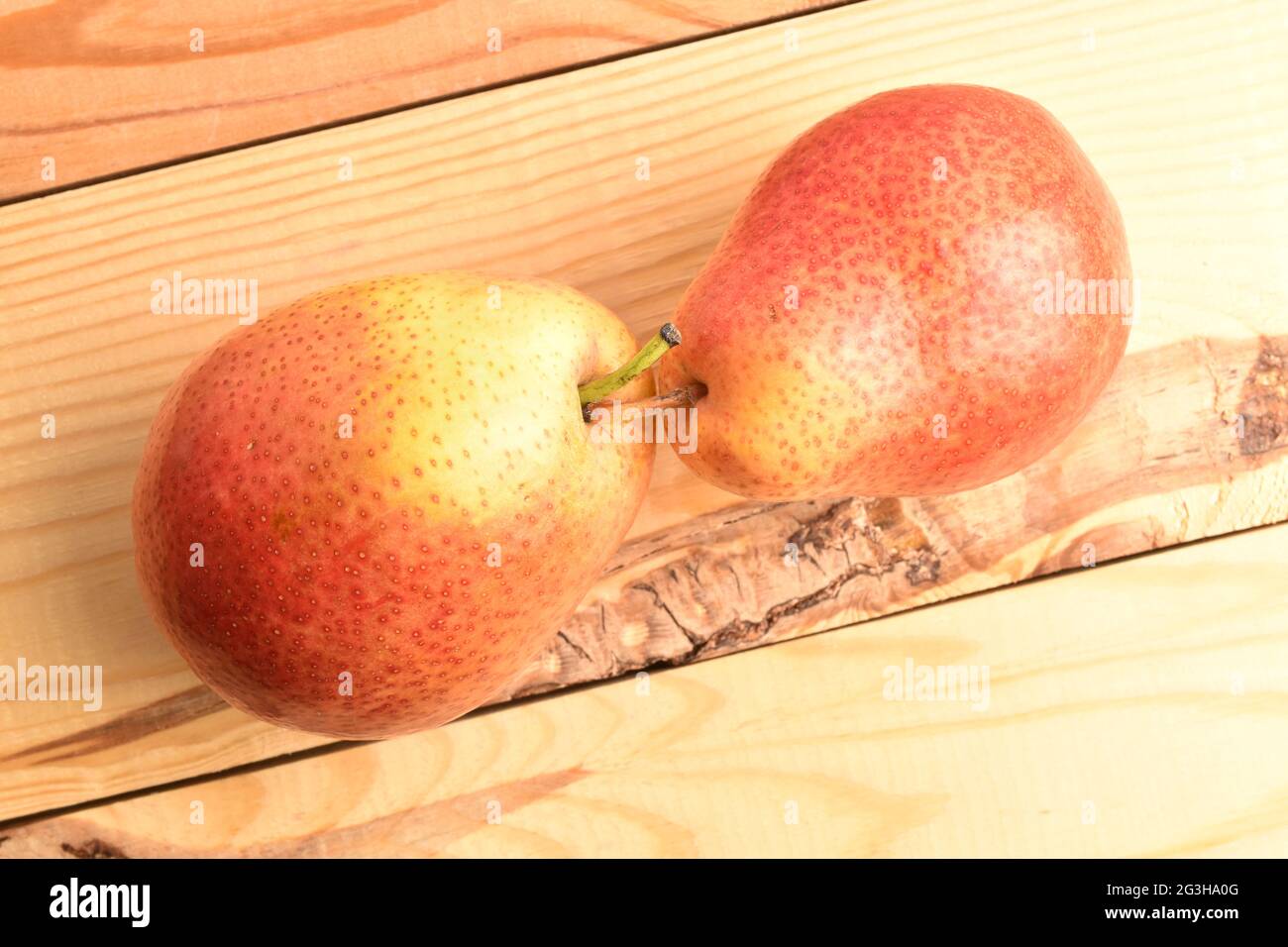 Two organic yellow-red pears, close-up, on a wood table, top view Stock ...
