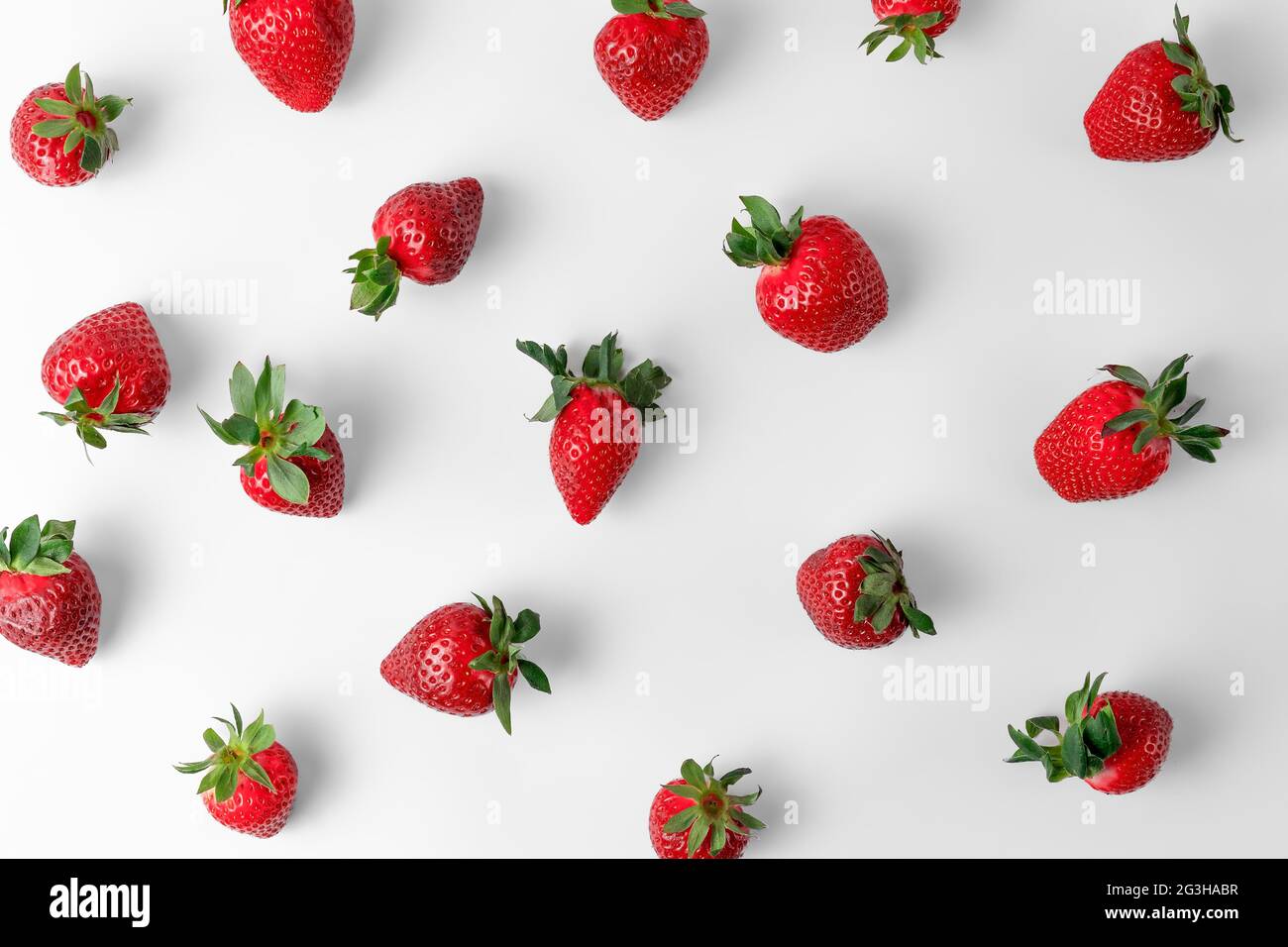 pattern with many red fresh whole strawberries on a white background ...