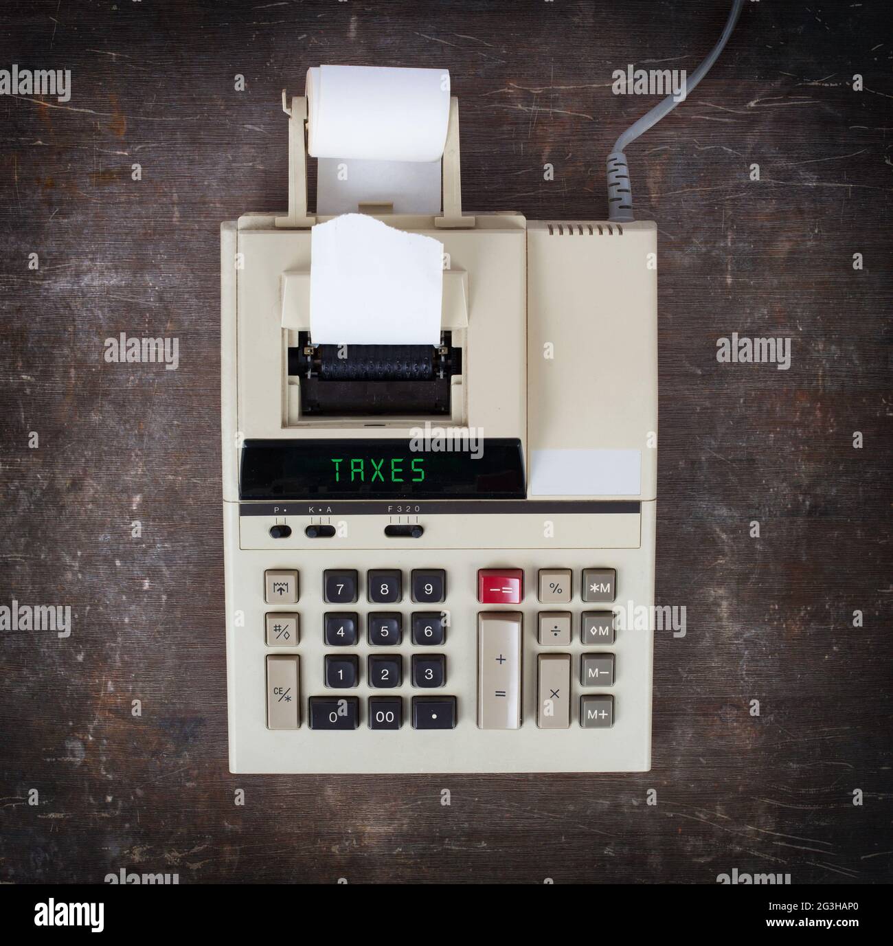 Old calculator - taxes Stock Photo - Alamy
