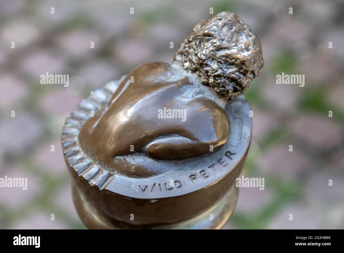 Bronze sculpture of Peter the wild boy, child, man, on a bollard in ...