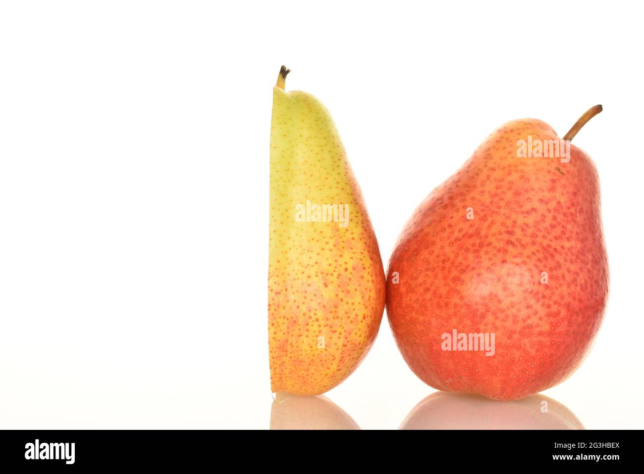 One whole and half a juicy pear, close-up, on a white background Stock ...